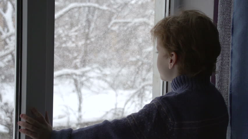Christmas Snowfall. Boy Looking Out The Window At The Falling Snow ...