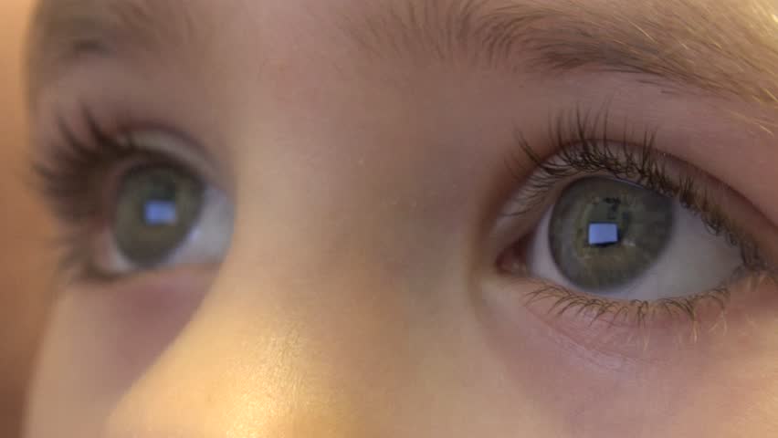 Closeup Of Happy Baby Girl Eyes Looking TV, Reflections In Eyes. 4K ...