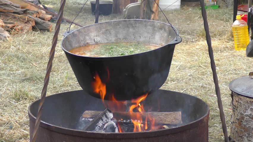 Cooking Outdoors In Cast-iron Cauldron. Cooking On A Fire. Food In A ...