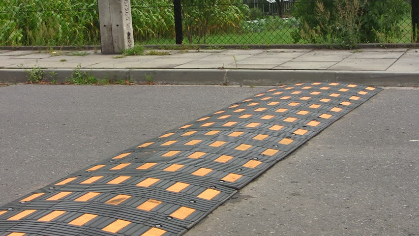 Car Driving Over Yellow Street Bump Stock Footage Video 1874821 ...