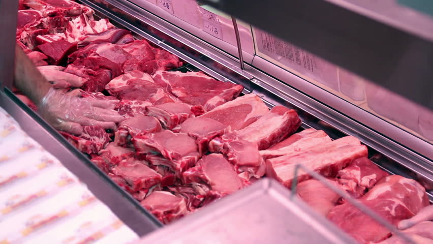 Butcher Arranging Meat In Display Case. Food Industry. Butcher's Hands ...