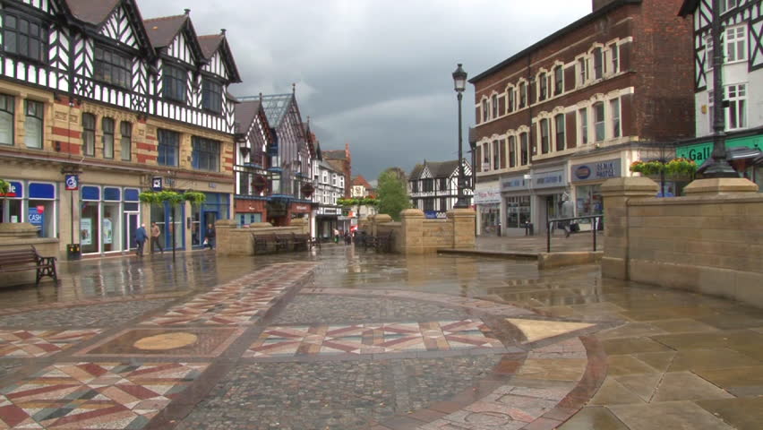 WIGAN, ENGLAND - CIRCA 2011: Man Walks Across Pedestrian Square In ...