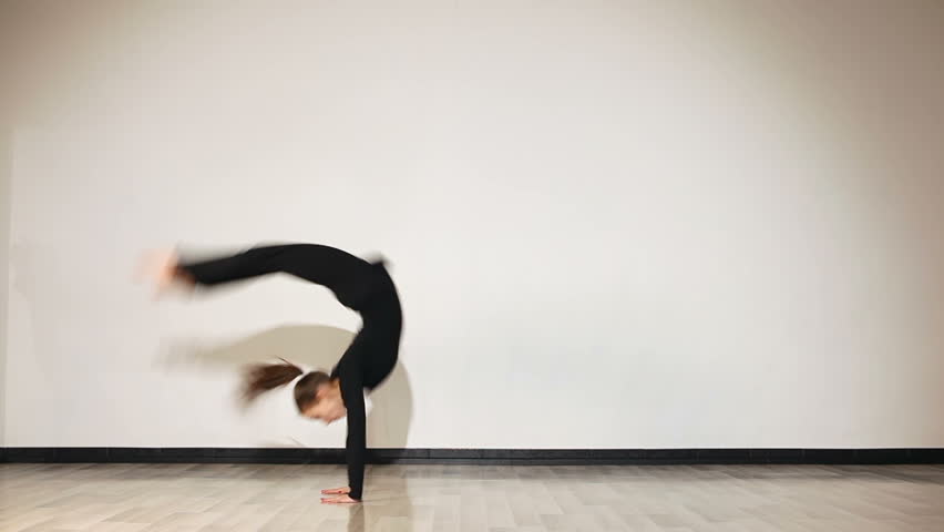 Flexible Female Doing Acrobatic Flip And Back-filp. Gymnastic Back Flip ...